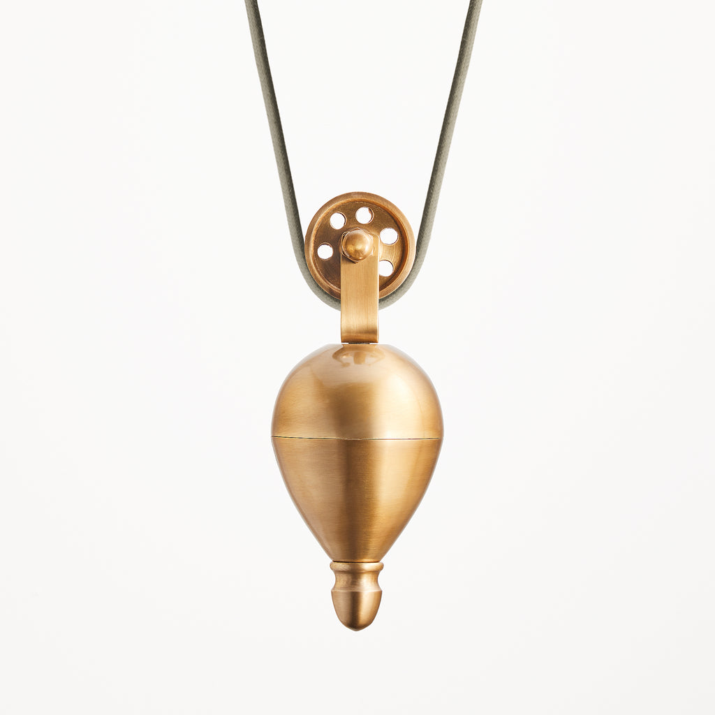 Equilibrium rise and fall pendant set in antique brass