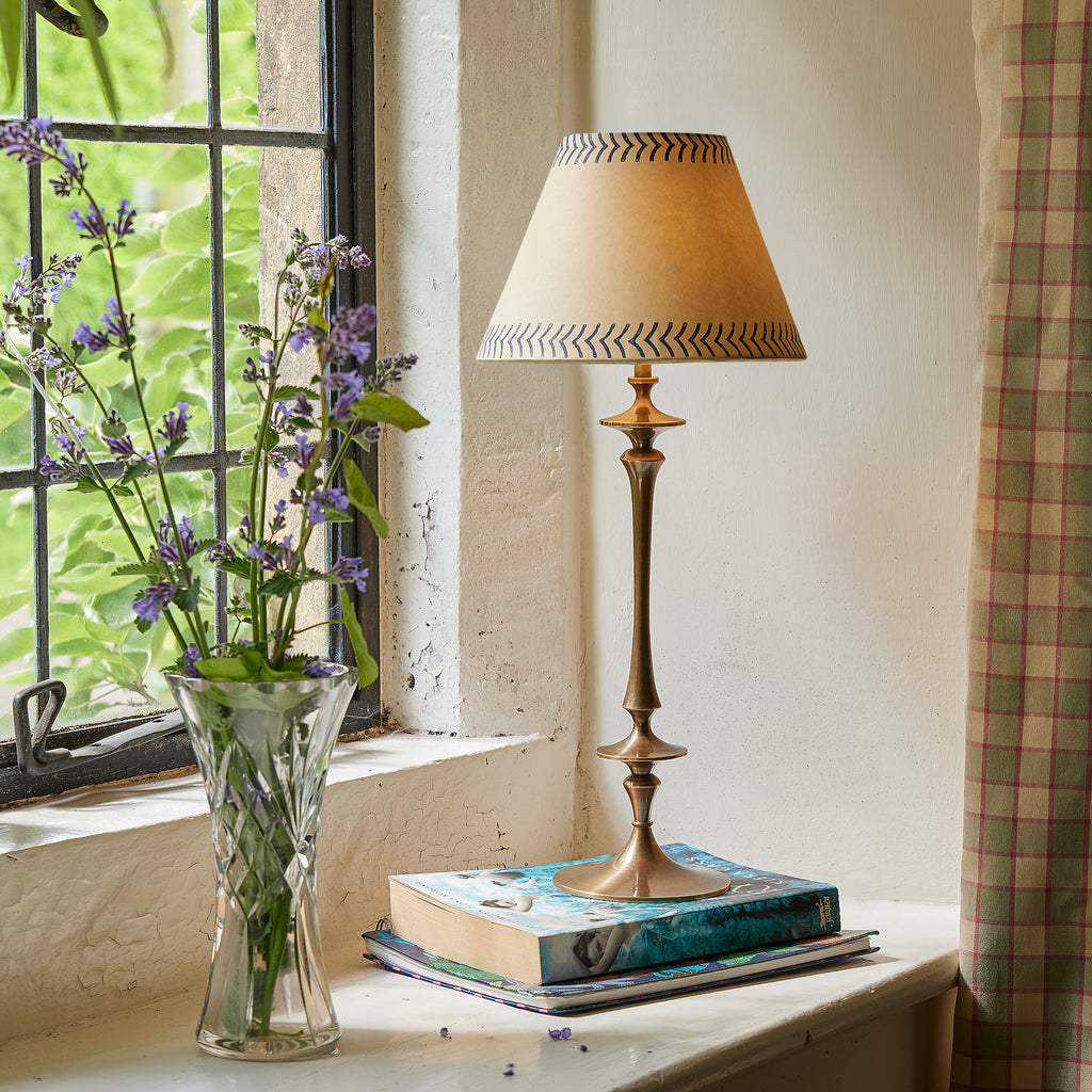 Spindle cordless table lamp in aged brass