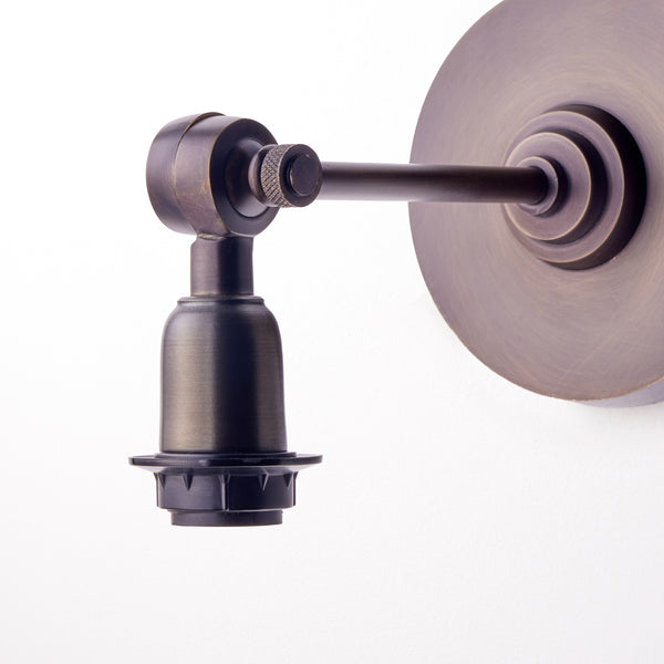 Elbow wall fixture in bronze