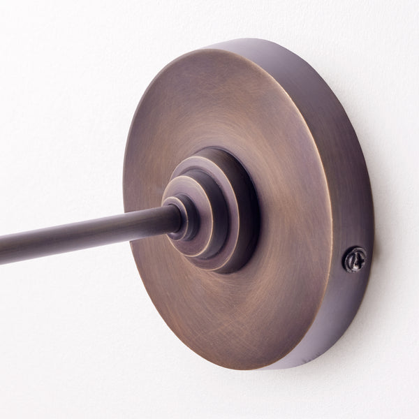 Elbow wall fixture in bronze