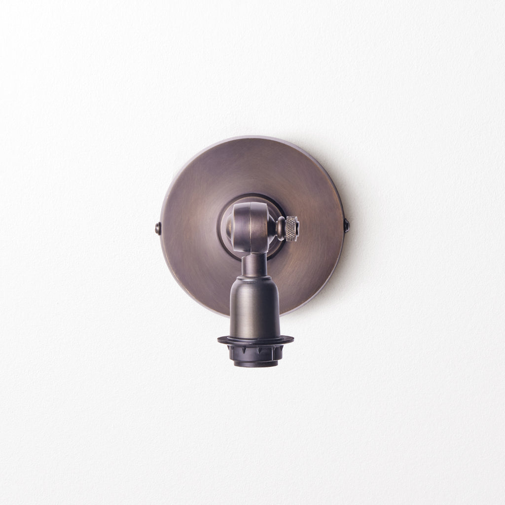 Elbow wall fixture in bronze