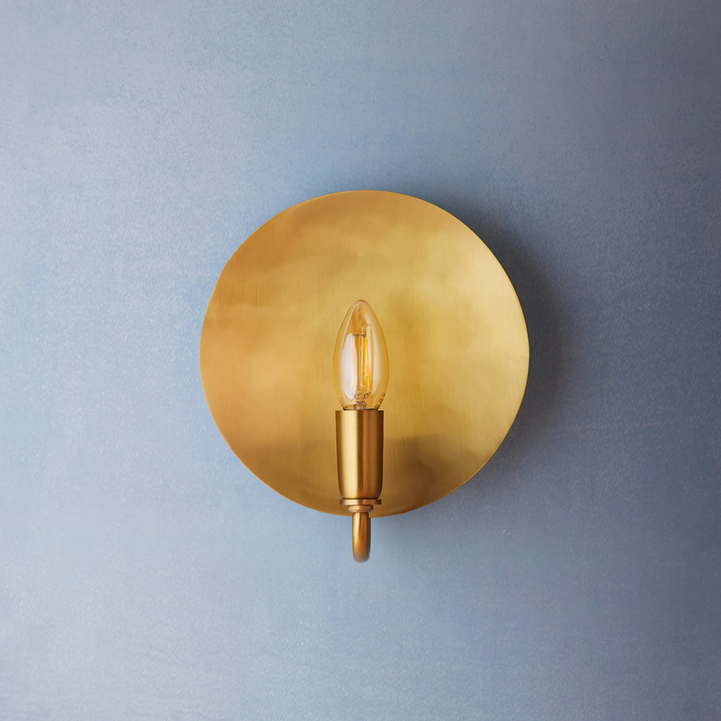 Moon wall sconce in antiqued brass