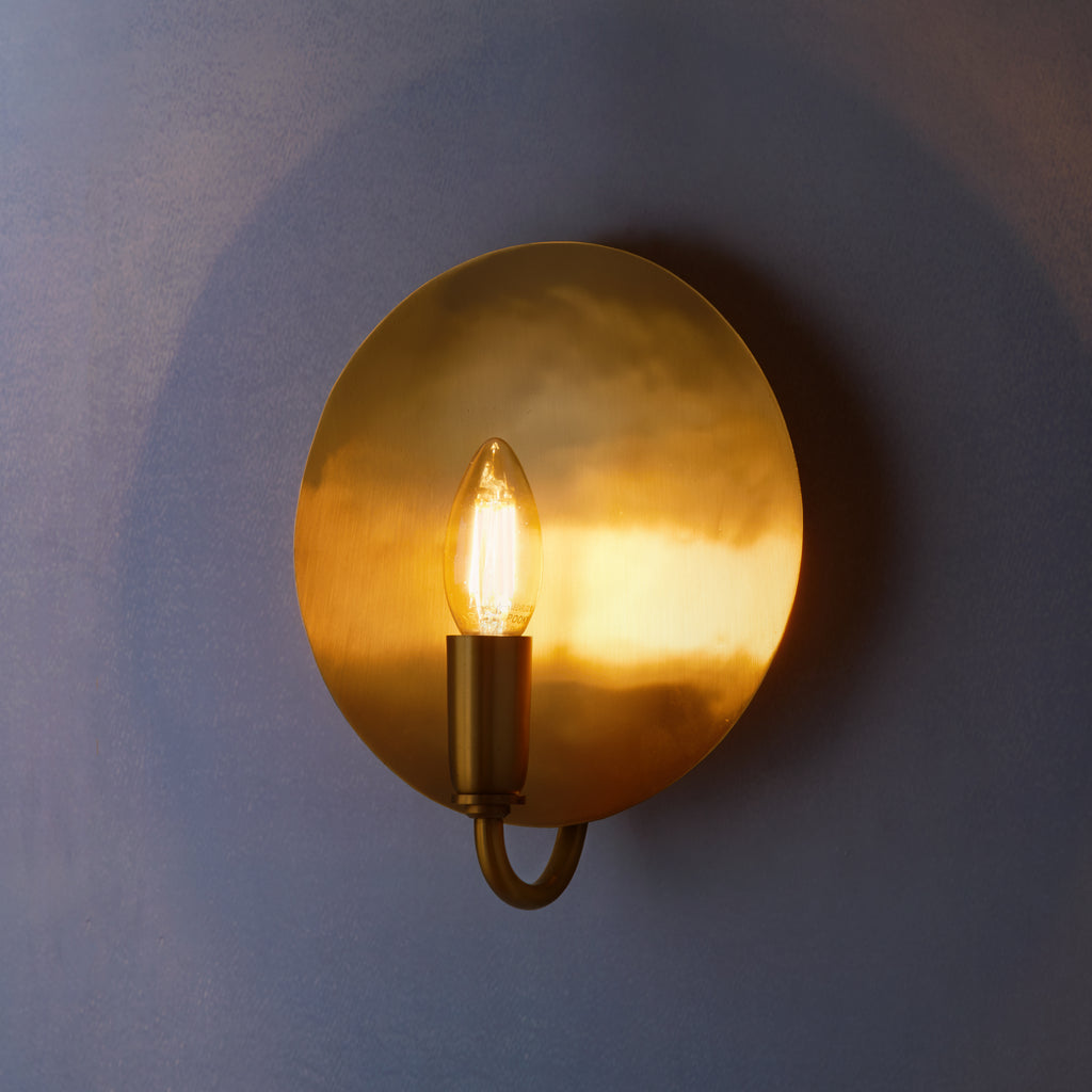 Moon wall sconce in antiqued brass