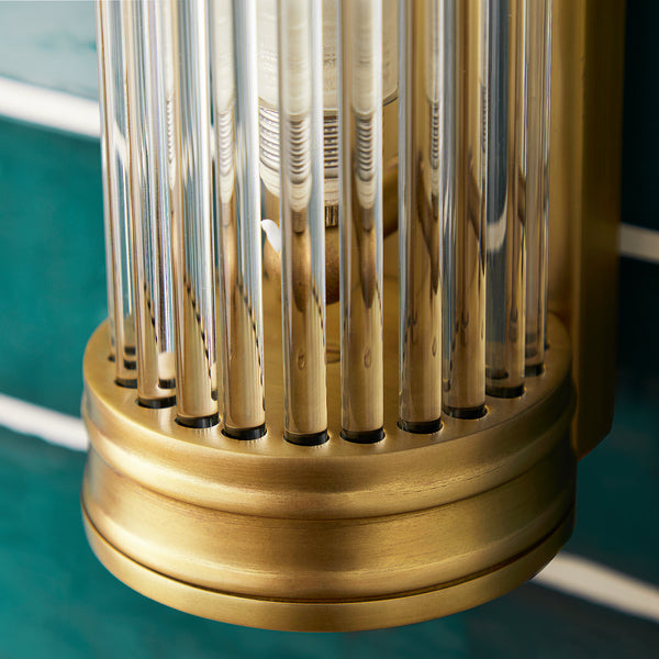 Long Roddy wall sconce in antiqued brass with glass rods