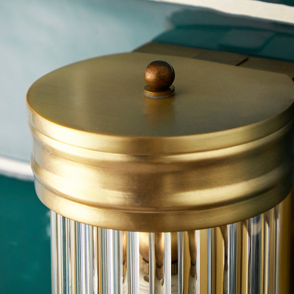 Long Roddy wall sconce in antiqued brass with glass rods