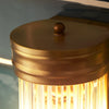 Long Roddy wall sconce in antiqued brass with glass rods