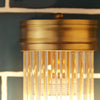 Long Roddy wall sconce in antiqued brass with glass rods