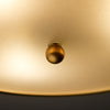 Round Roddy flush mount ceiling light in antiqued brass and clear glas
