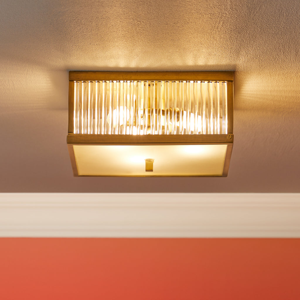 Square Roddy flush mount ceiling light in antiqued brass and clear gla