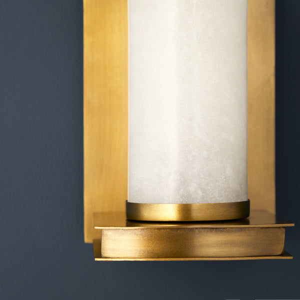 Roly wall sconce in antiqued brass with an alabaster tube